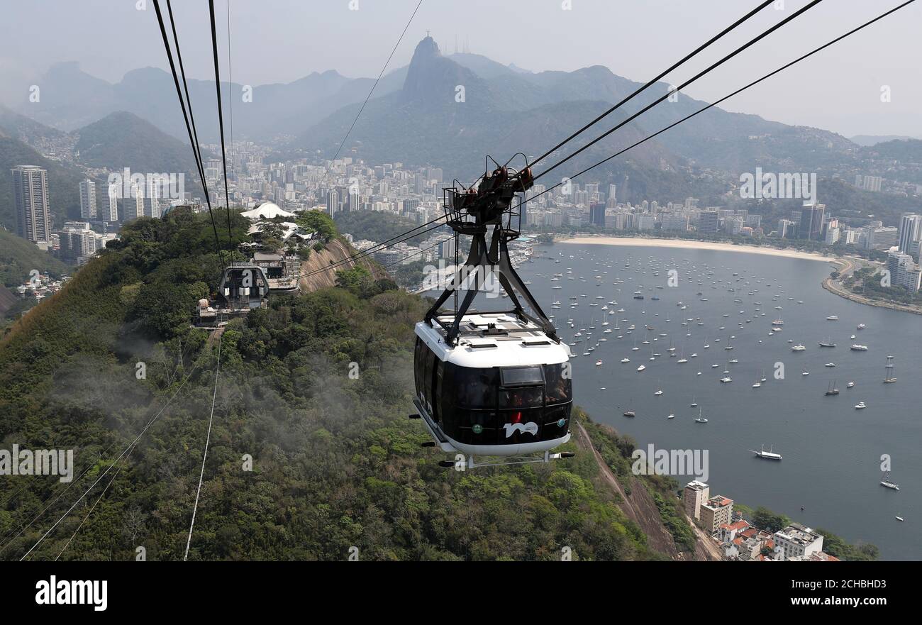 A cable car makes it's way up to the top of Sugarloaf mountain from ...