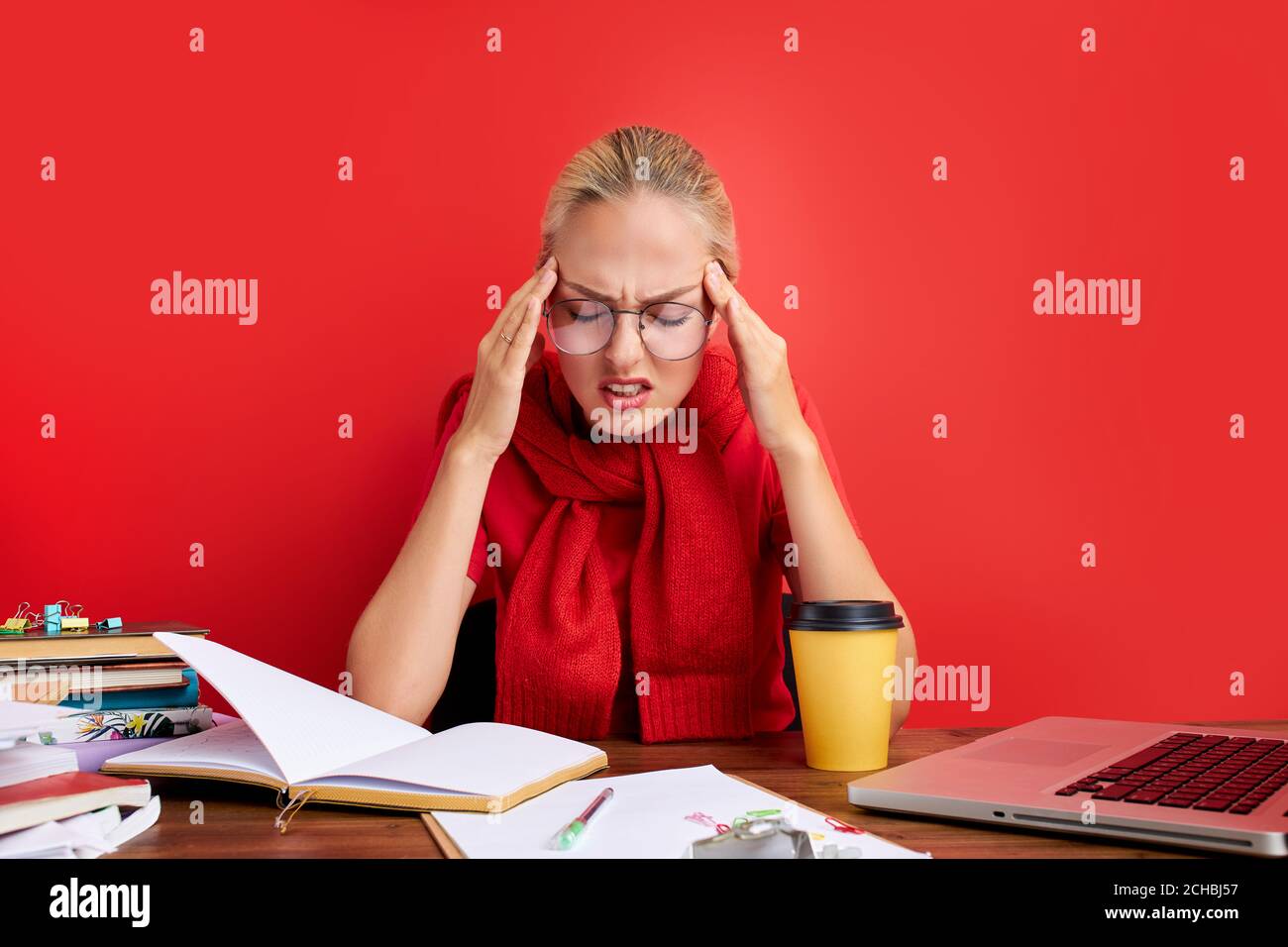 woman has head burst at work, she is suffering from head ache, sit with ...