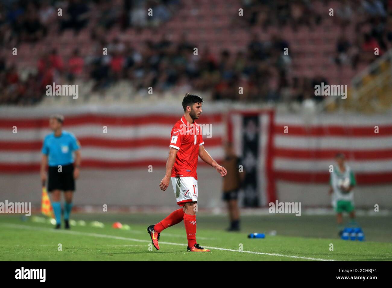 Malta's Luke Gambin walks off dejected after being shown the red card ...