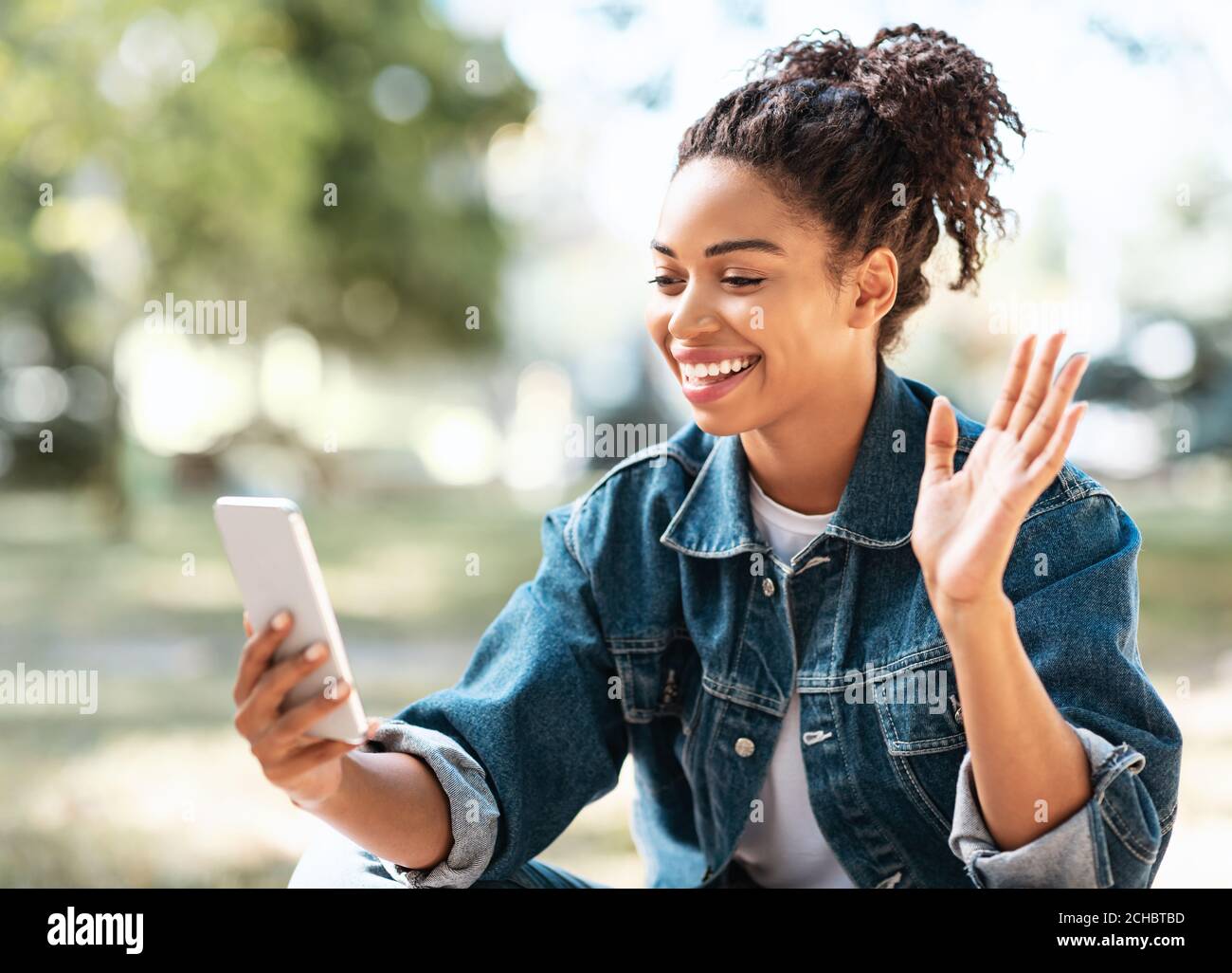 Black Woman With Cellphone Making Video Call Waving Hello Outside Stock ...