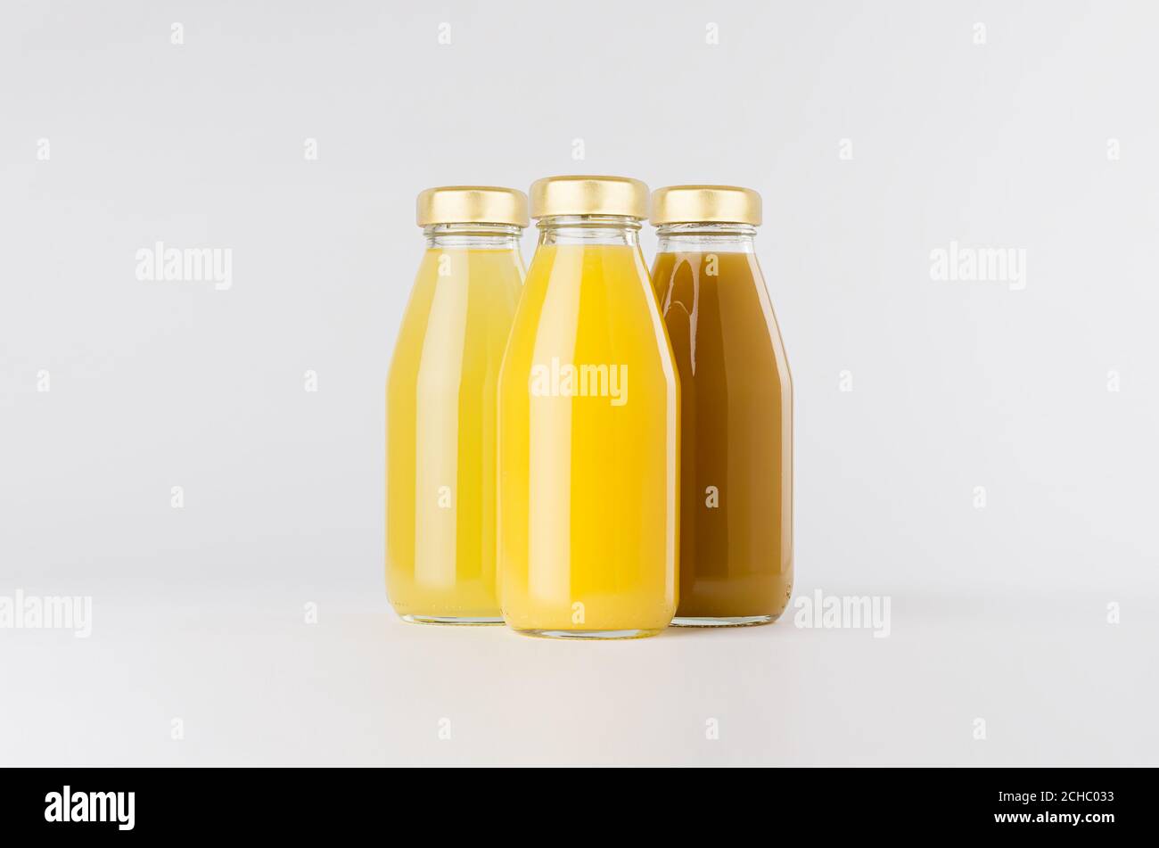 Orange, yellow fruit juices collection mock up in glass bottles with ...