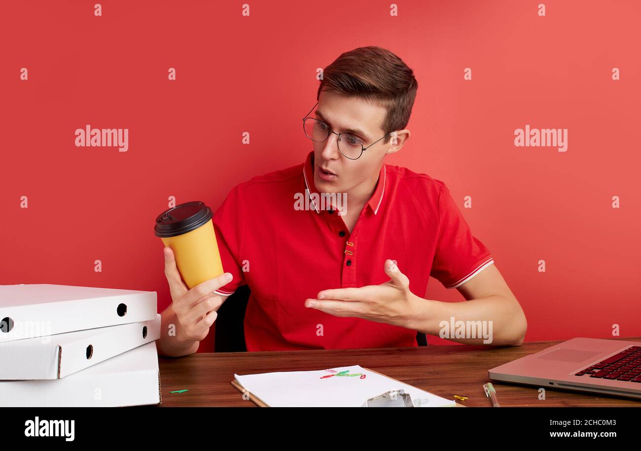 shocked male look at cup of coffee at work, surprised by it's effect ...