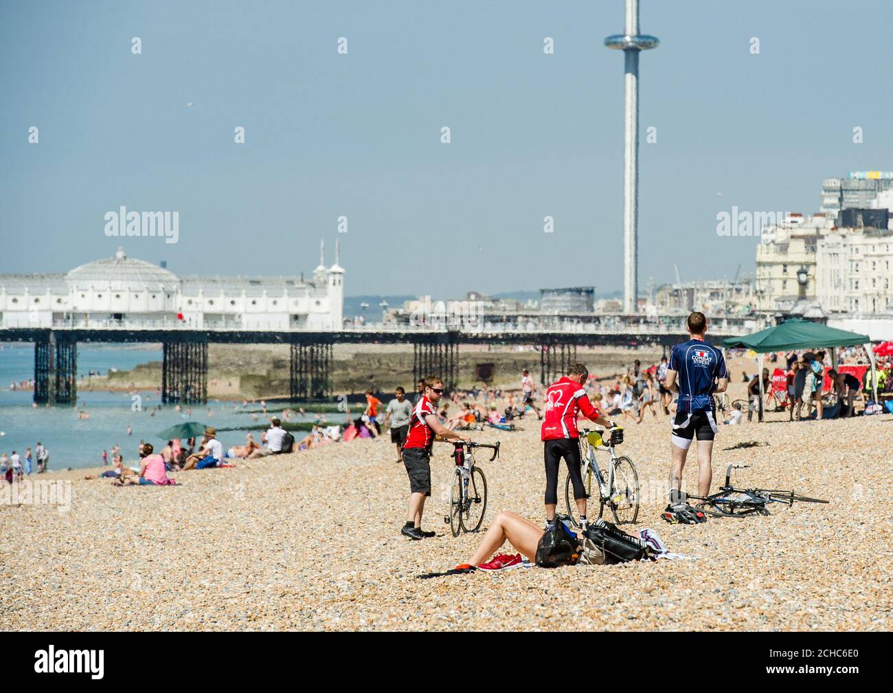 EDITORIAL USE ONLY Cyclists take a much deserved rest on Brighton Beach ...