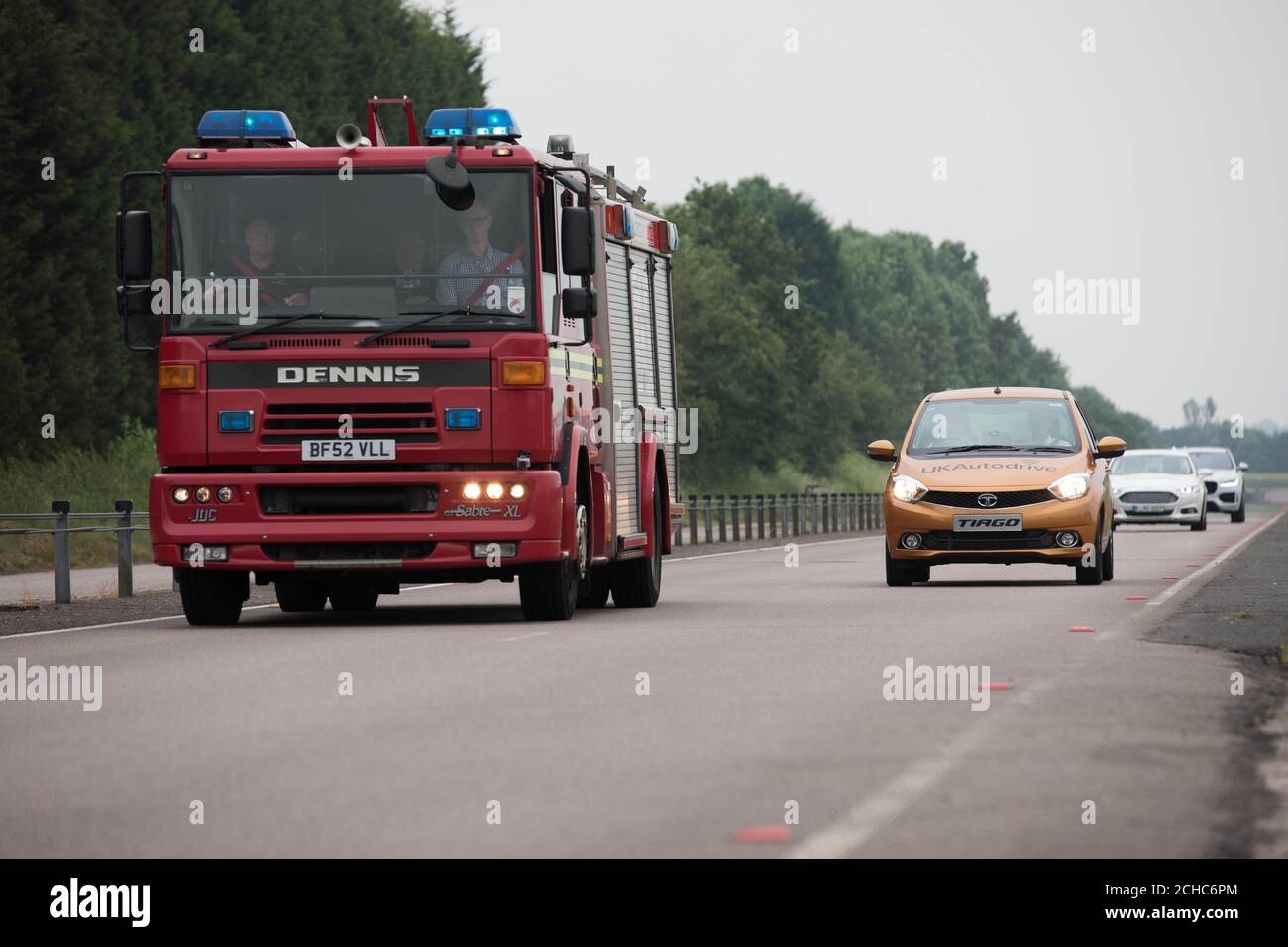 EDITORIAL USE ONLY A West Midlands Fire Service engine overtakes a line ...
