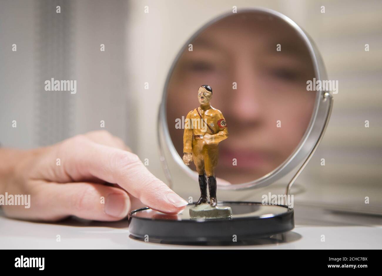 EDITORIAL USE ONLY Curator Anna Farthing with a figure of Adolf Hitler ...