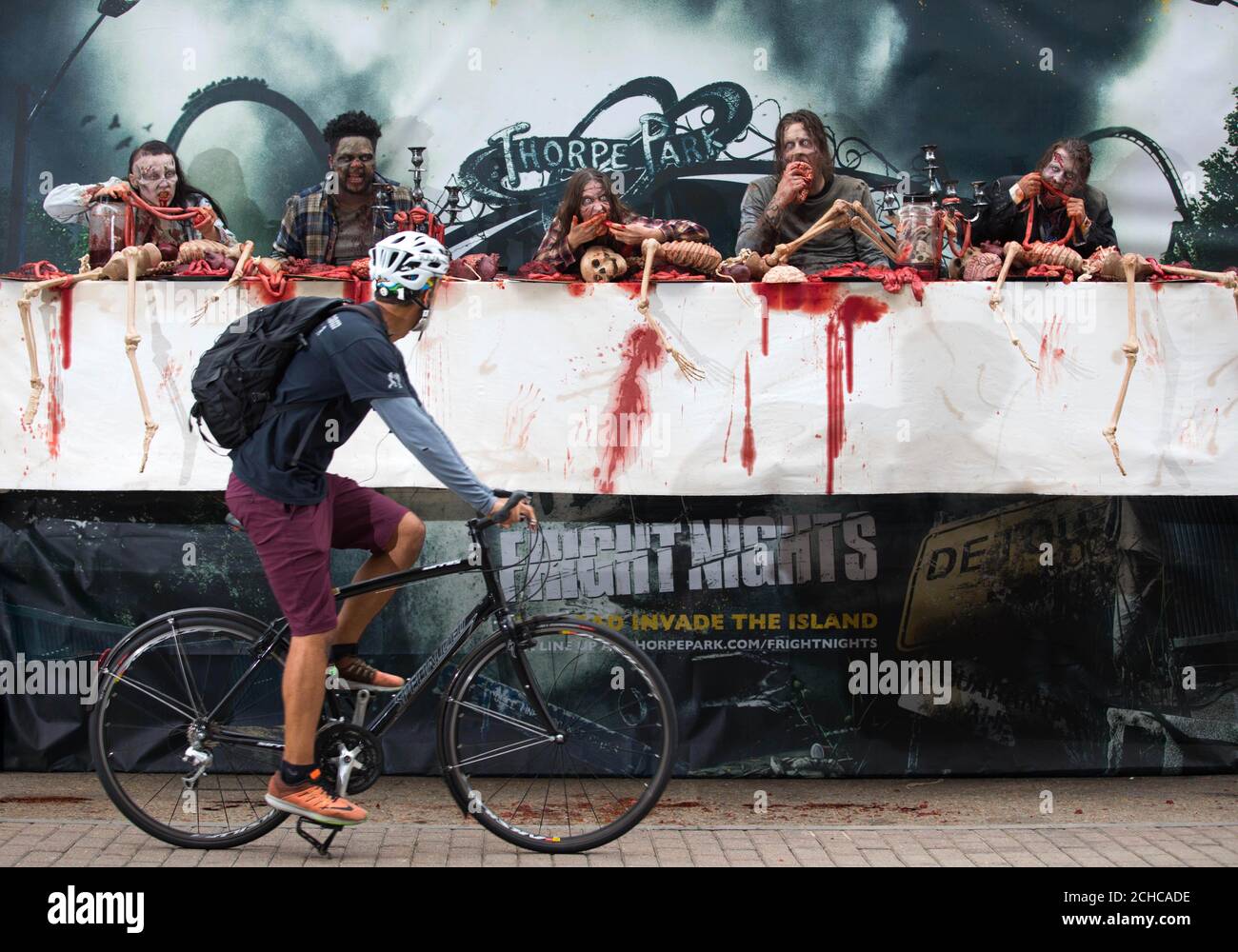 People dressed as zombies appear in an interactive billboard in ...