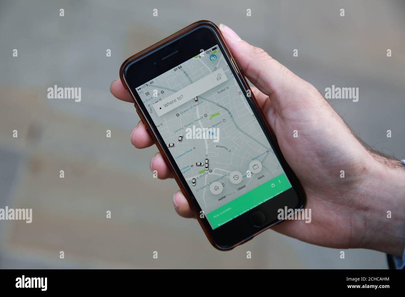 A man using an Uber App on his mobile phone Stock Photo - Alamy