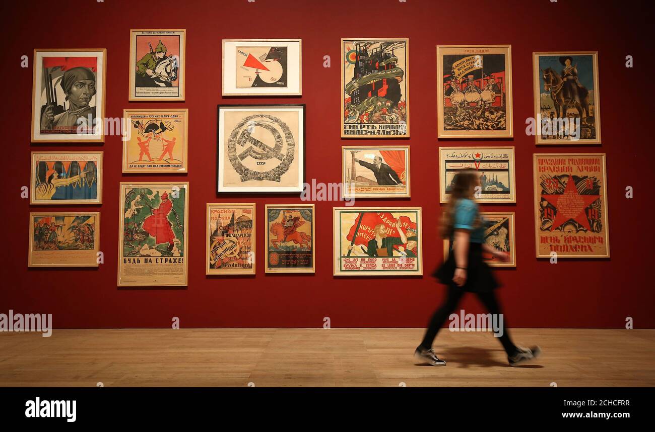 A School child from Thomas Tallis School walks past pictures on display ...