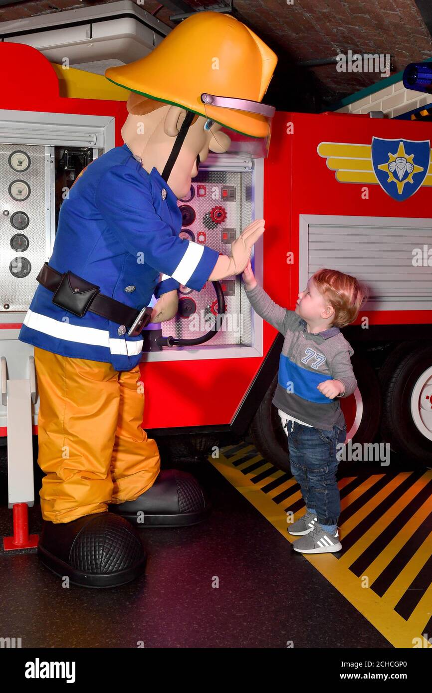 EDITORIAL USE ONLY Riley Gore, 2, from Litherland, meets Fireman Sam as ...