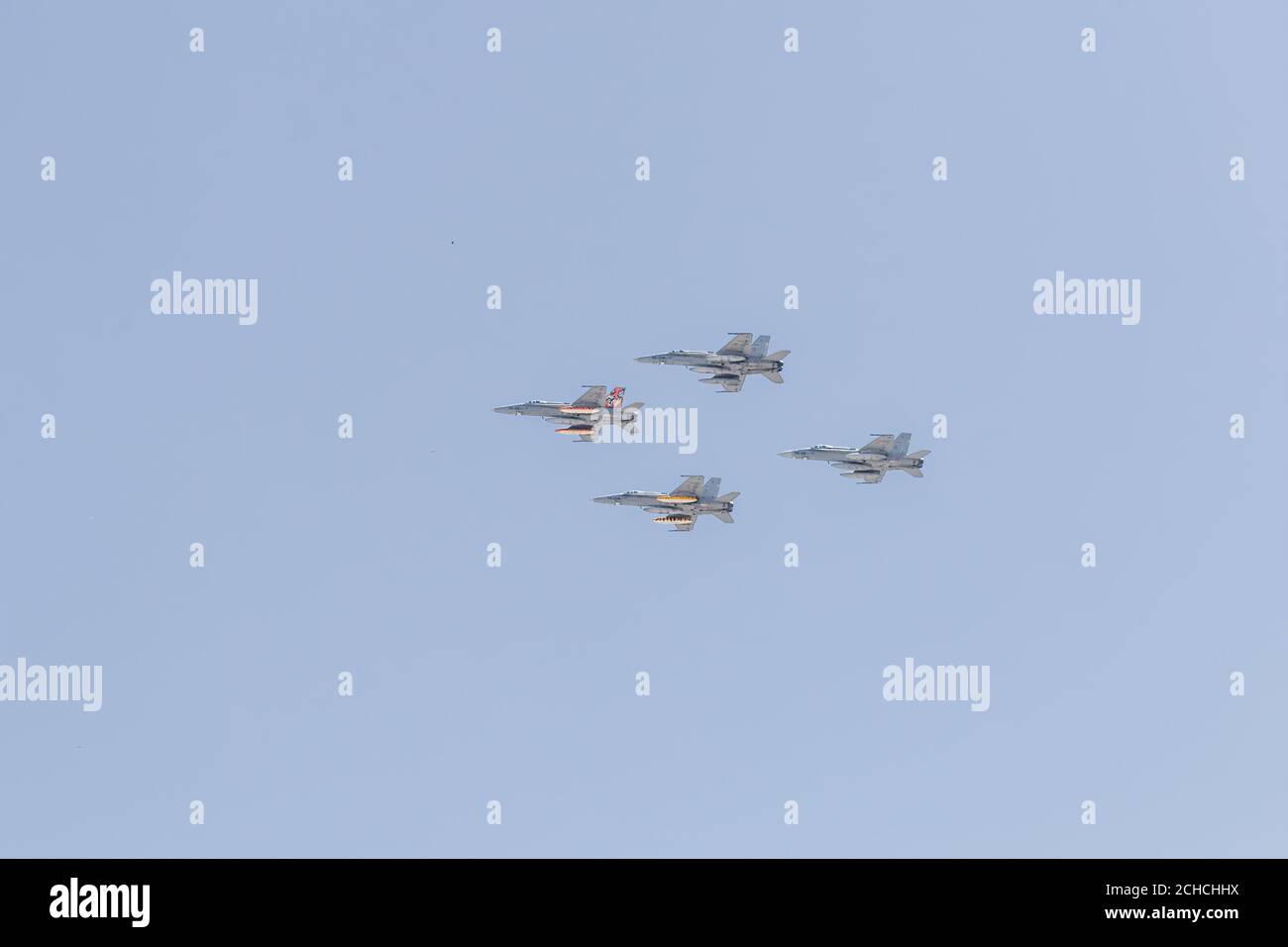 Modern armed military fighter jets flys in formation through the sky ...
