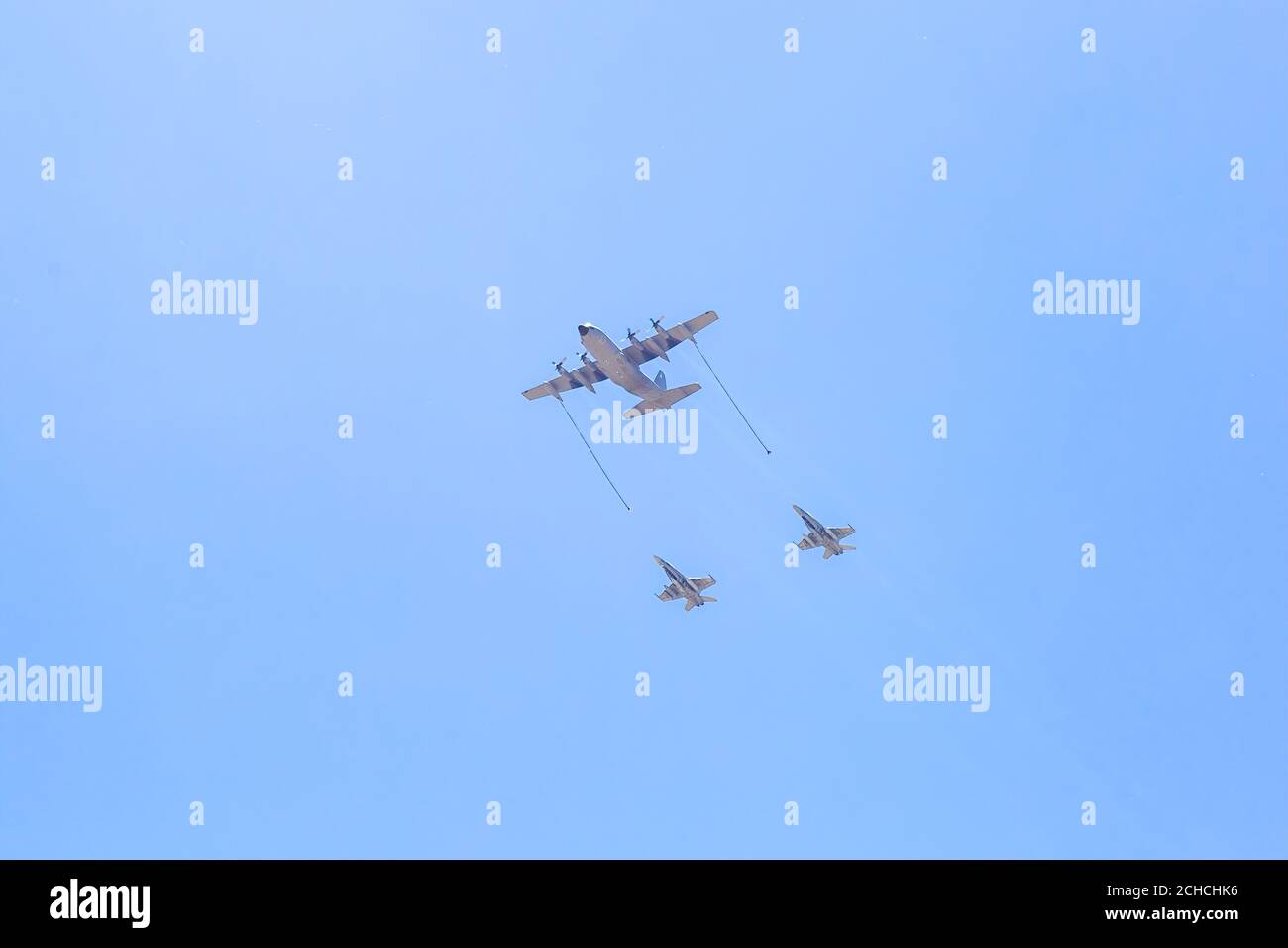 Modern armed military fighter jets flys in formation through the sky ...