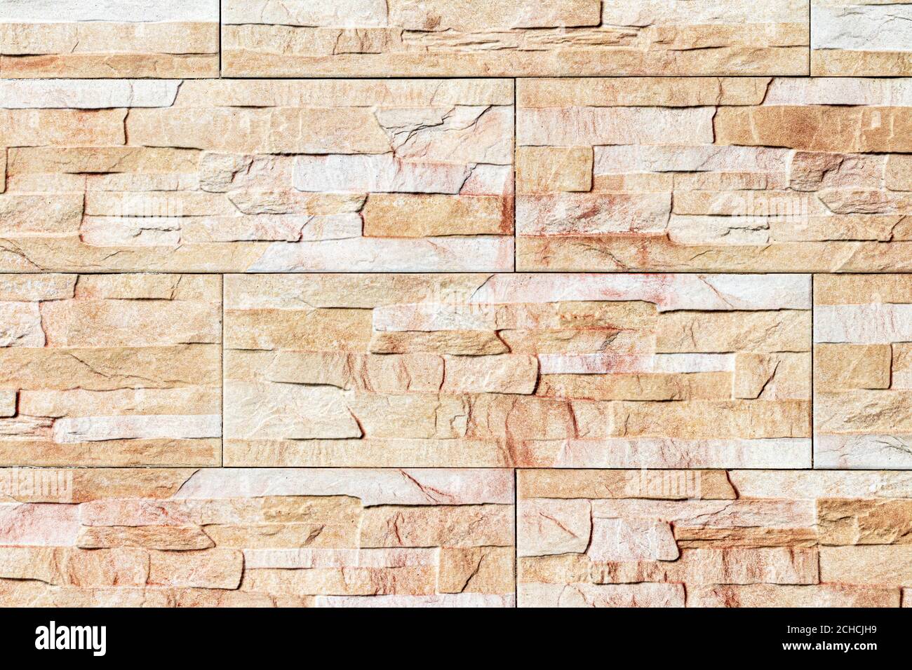 Monochrome texture of a wall covered with decorative brick-like tiles ...