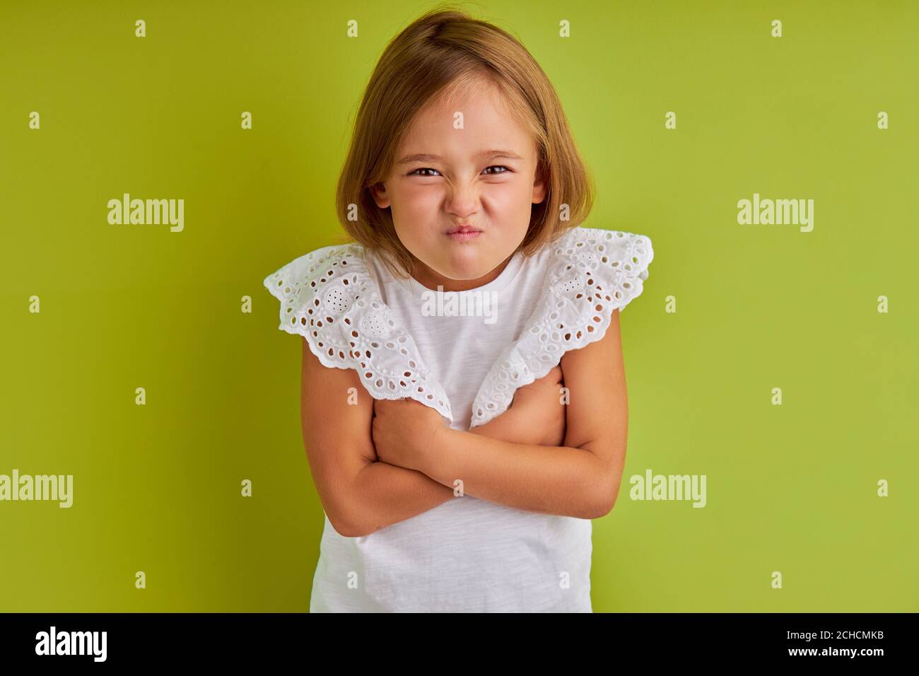 caucasian emotional little girl puff out, isolated background. look at ...