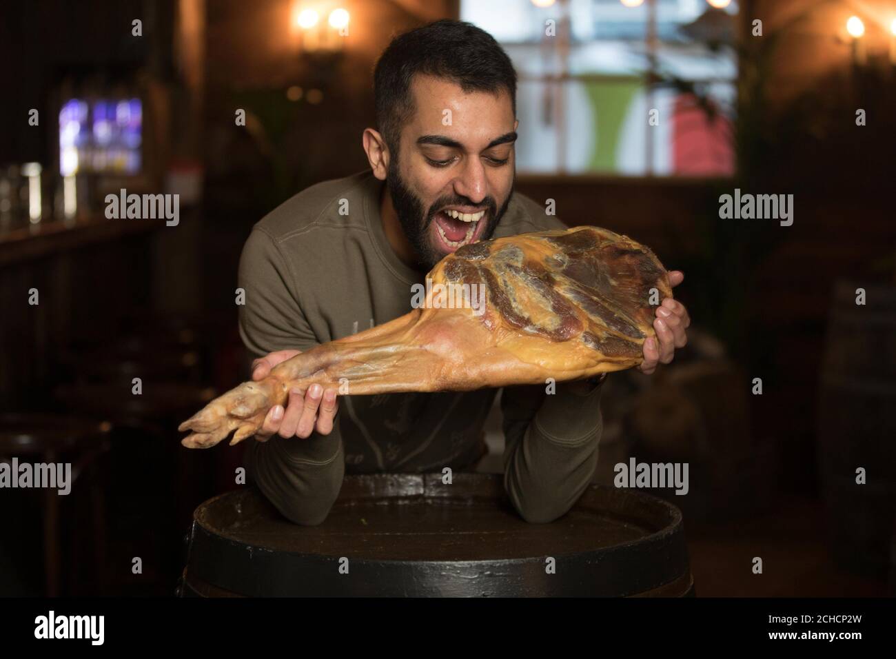 EDITORIAL USE ONLY Sheeaz Gulshar tucks into a meat platter at a ...