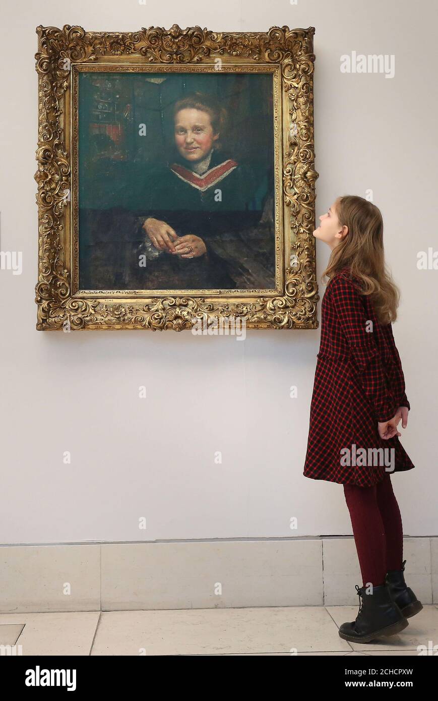 Stella Cartwright aged 9, looks at Annie Swynnerton's portrait of ...