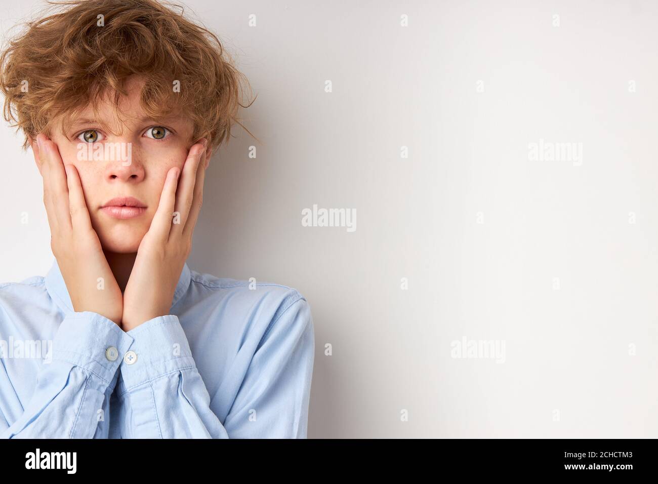 scared curly boy afraid of something, expressive emotional boy cannot ...