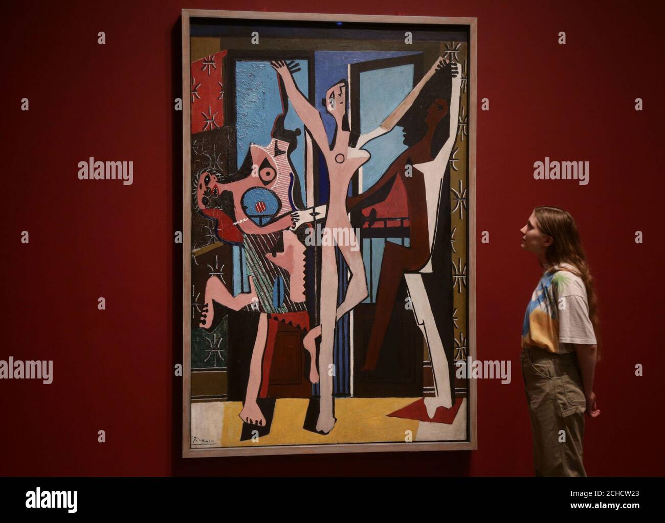 A woman looking at Pablo Picasso's The Three Dancers, 1925, during a preview of the exhibition ...