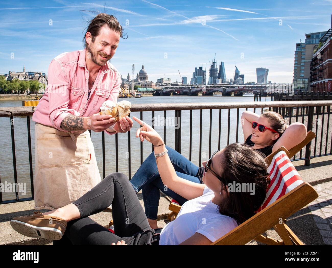 EDITORIAL USE ONLY Chef James Strawbrige offers Hannah Skinnard and Kat ...