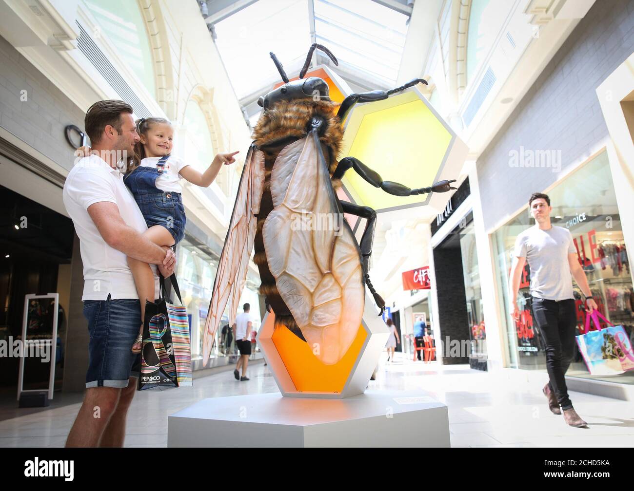 Lee Riddell and daughter Eva, aged 6, interact with a 4ft tall lifelike ...