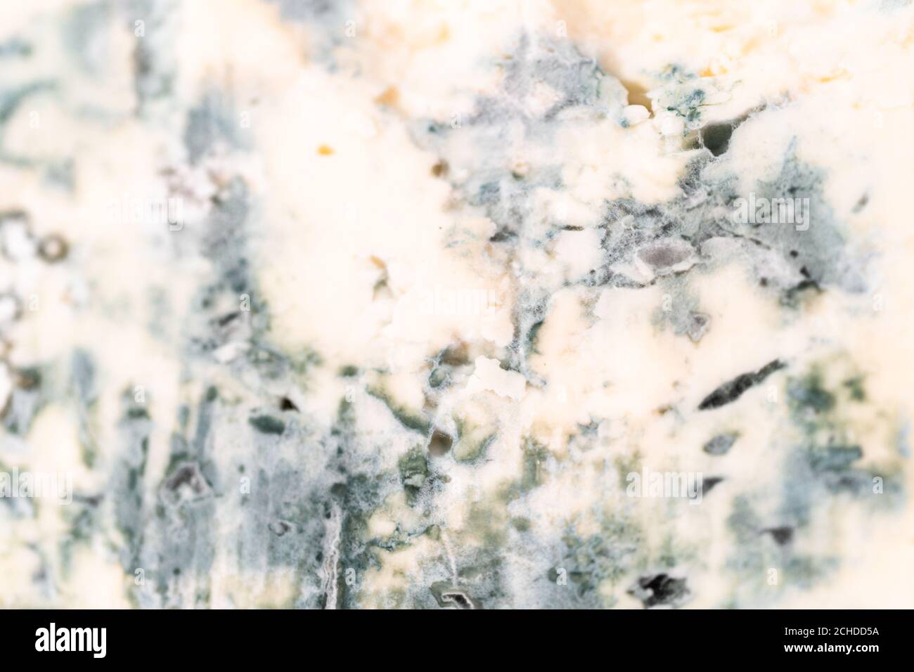 Large slice of blue cheese on a white background Stock Photo - Alamy