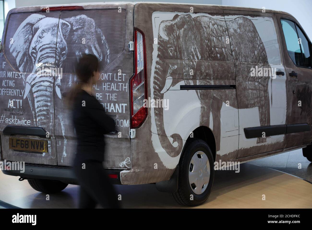 Artist Ricky Minns, aka 'Ruddy Muddy' creates a piece of artwork on a ...