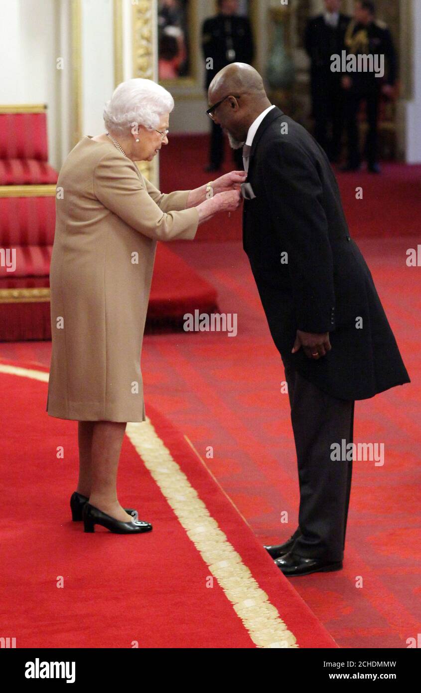 Is made an mbe by the queen at buckingham palace hi-res stock ...