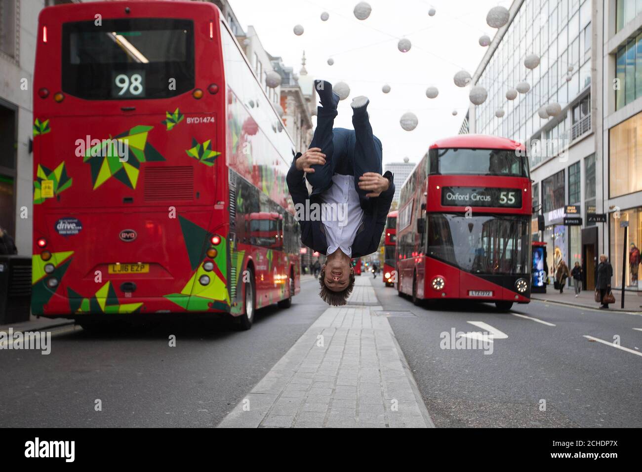 Gymnast Benjamin Jones performs a back somersault on Oxford Street in ...