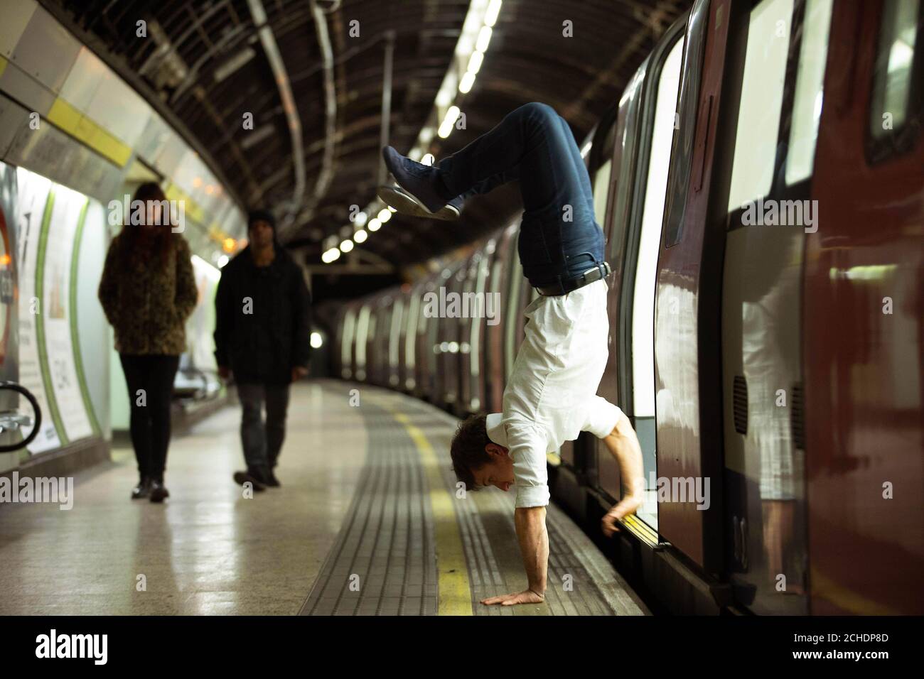 Gymnast Benjamin Jones walks on his hands on the London Underground to ...