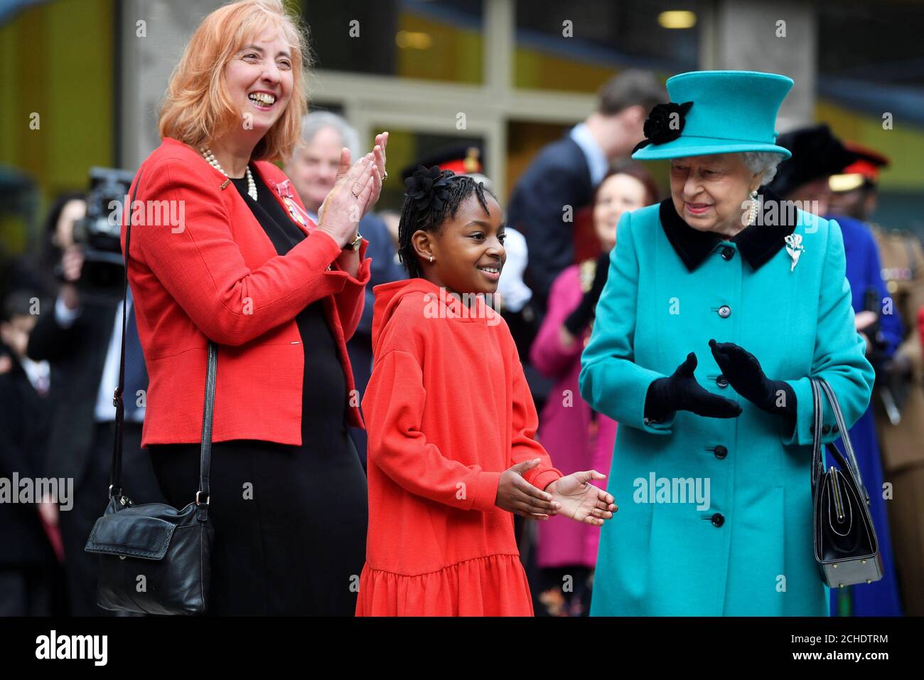 Queen Elizabeth II (right) with Shylah Gordon, aged 8, and Coram CEO ...
