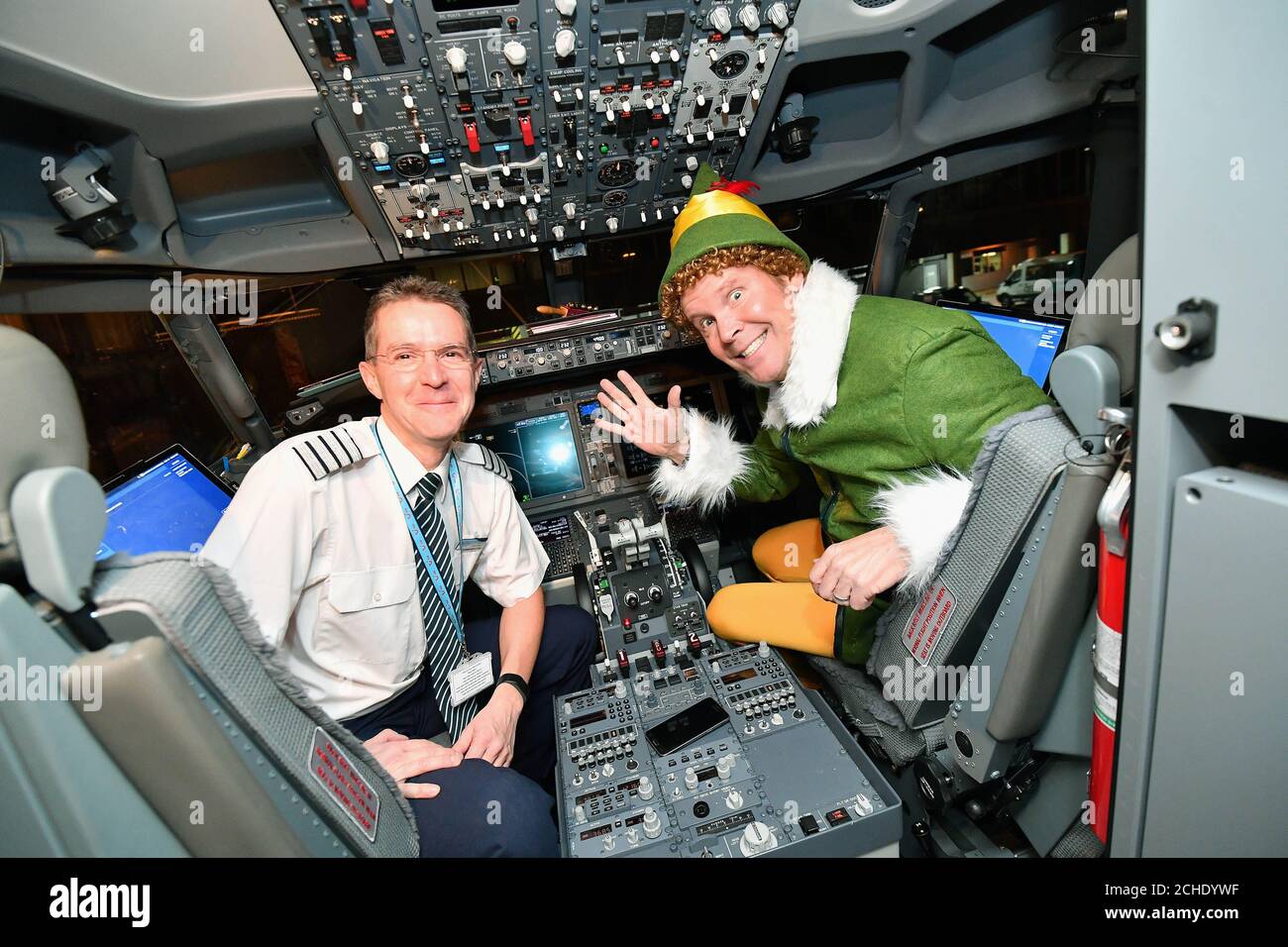 EDITORIAL USE ONLY A Buddy the Elf lookalike poses with the pilot on ...
