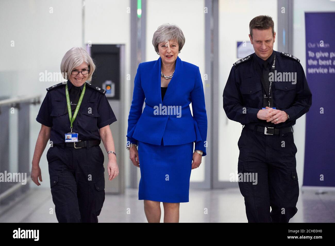 Prime Minister Theresa May walks with UK Border Force officers during a ...