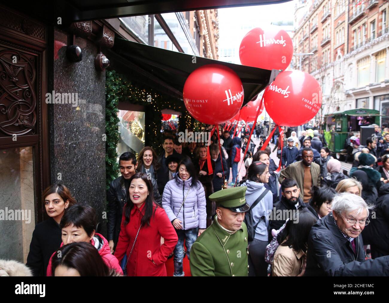 EDITORIAL USE ONLY Shoppers queue outside Harrods in Knightsbridge ...
