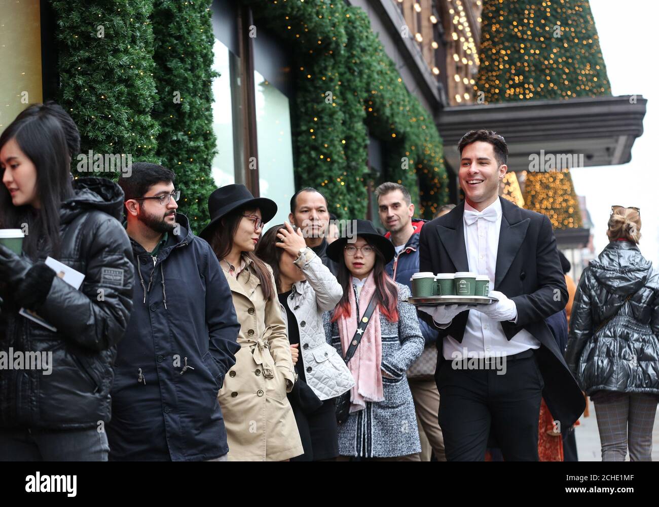 EDITORIAL USE ONLY Harrods butlers entertain shoppers as they queue ...