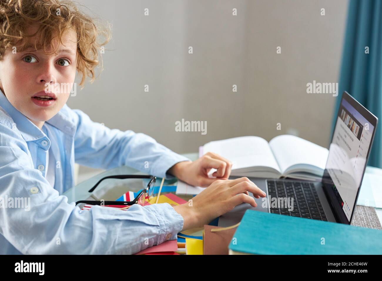 schoolboy is typing report on laptop, do homework. caucasian teen boy ...