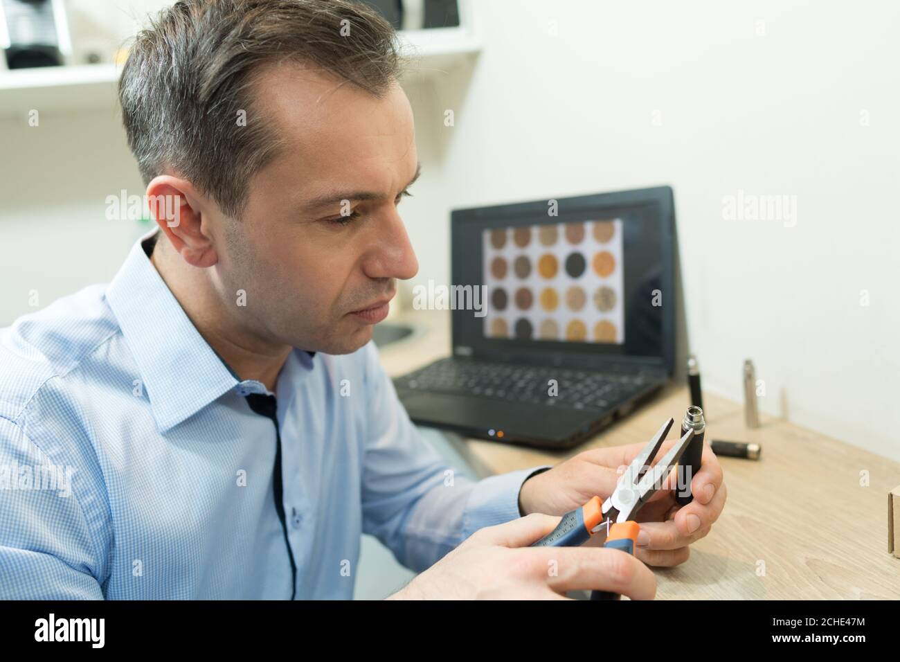 man fixing circuit board using screwdriver Stock Photo - Alamy