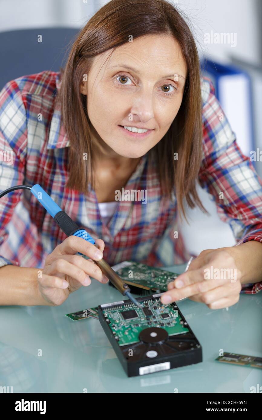 a female pc technician soldering pc part Stock Photo - Alamy