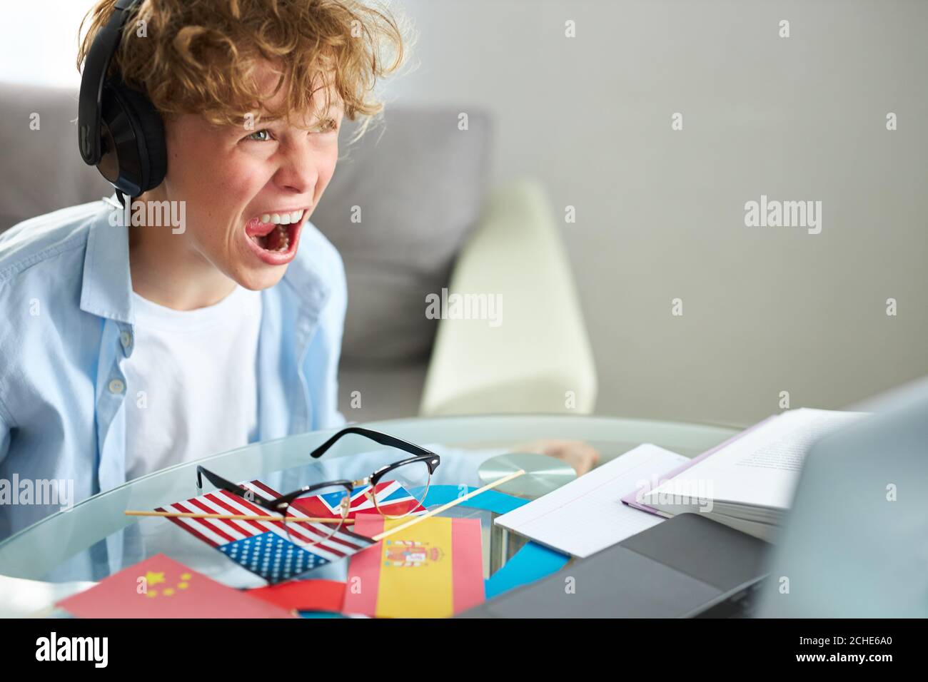 schoolboy scream looking at laptop, playing game between time of dong ...