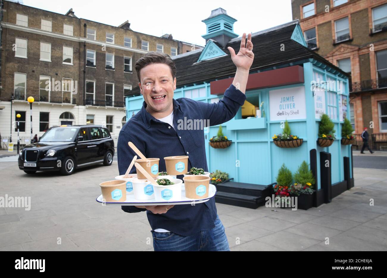 EDITORIAL USE ONLY Jamie Oliver hands out food at his bitesize pop-up ...