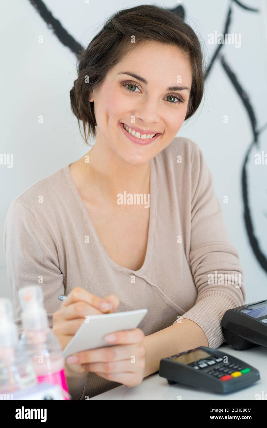 smiling young worker counting money Stock Photo - Alamy