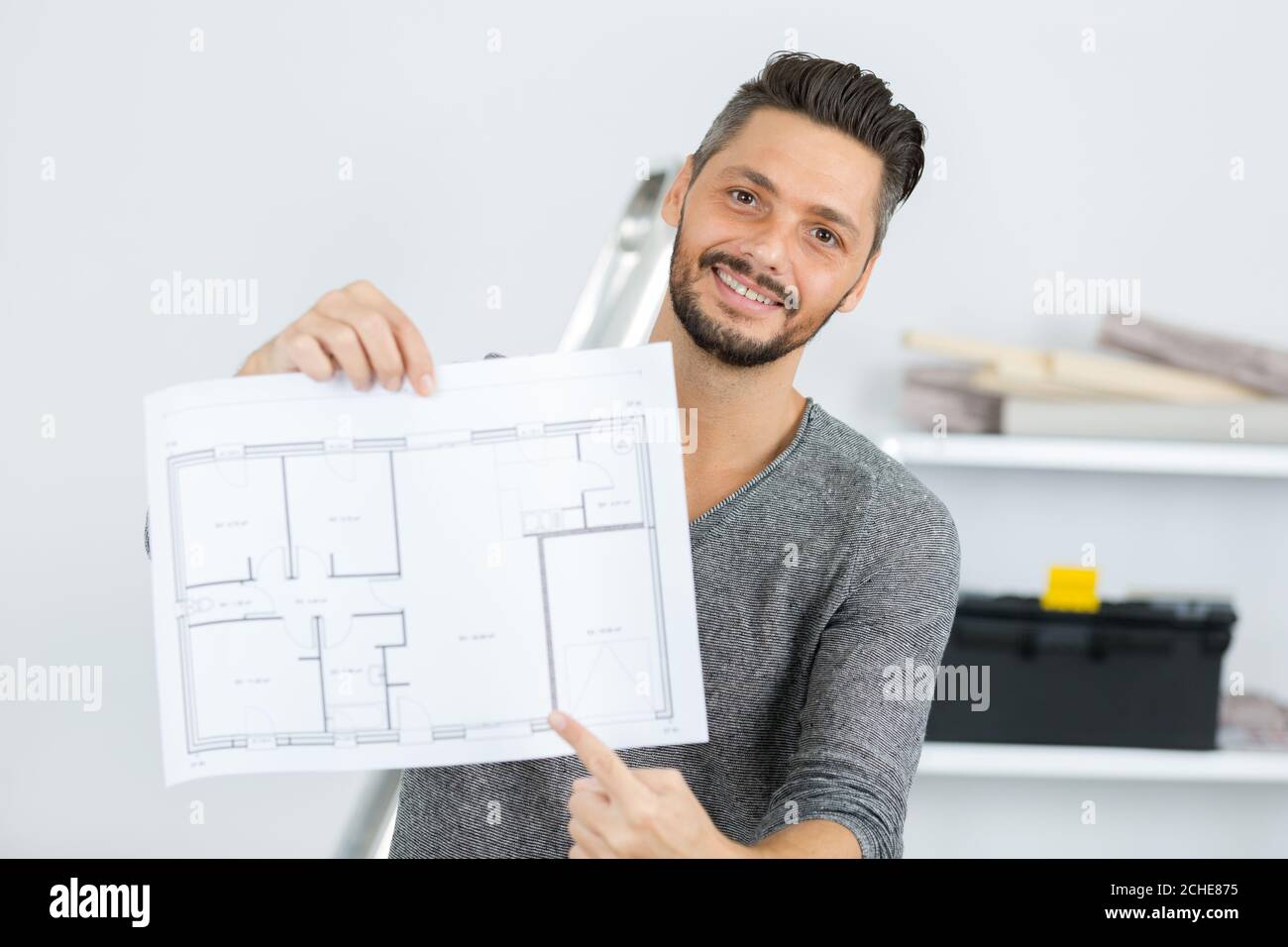 man showing blueprint to the camera Stock Photo - Alamy