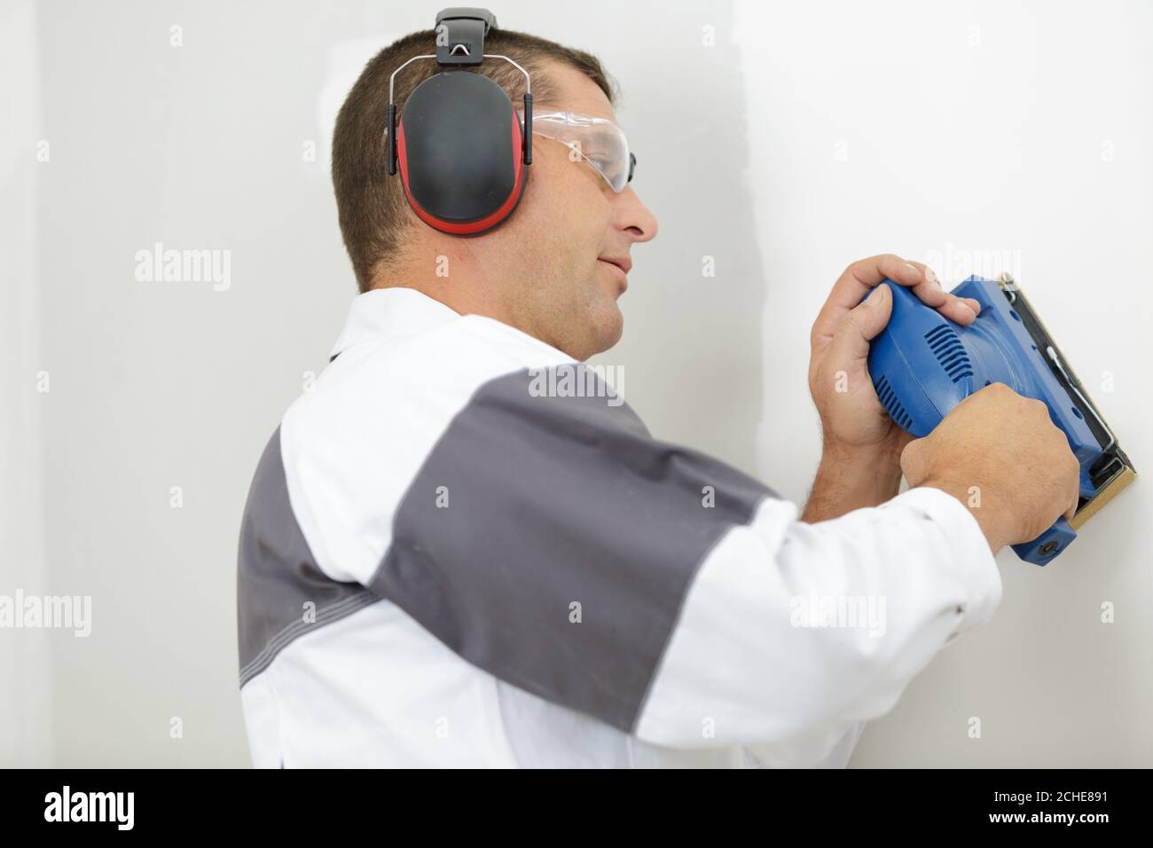 polishing a wall with sandpaper Stock Photo - Alamy