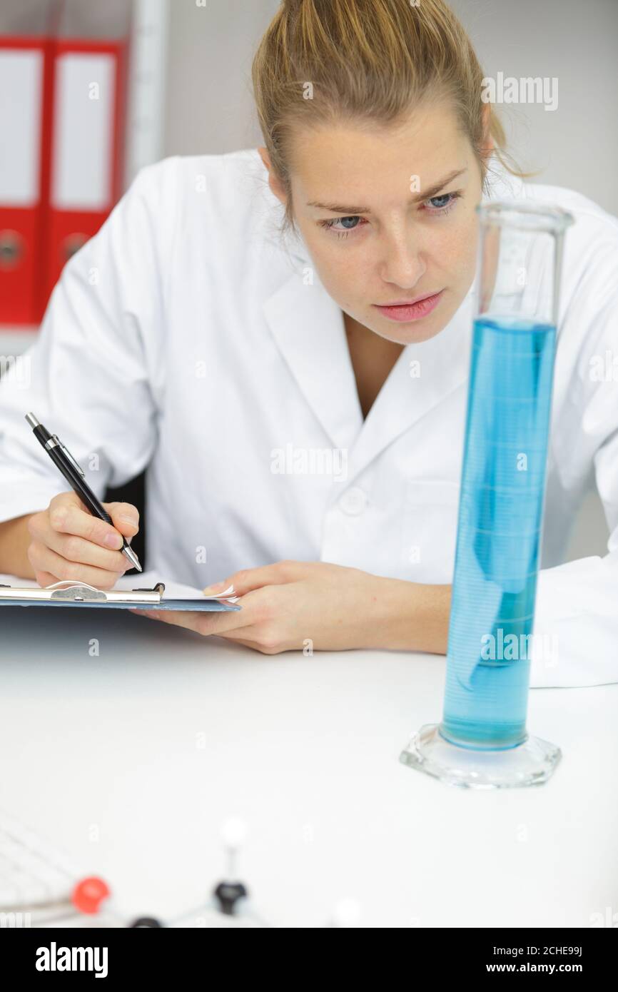 female lab worker analyzing pipette Stock Photo - Alamy