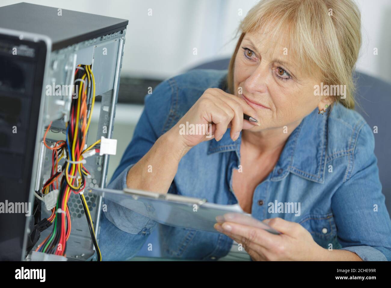 woman checking the state of a pc Stock Photo - Alamy