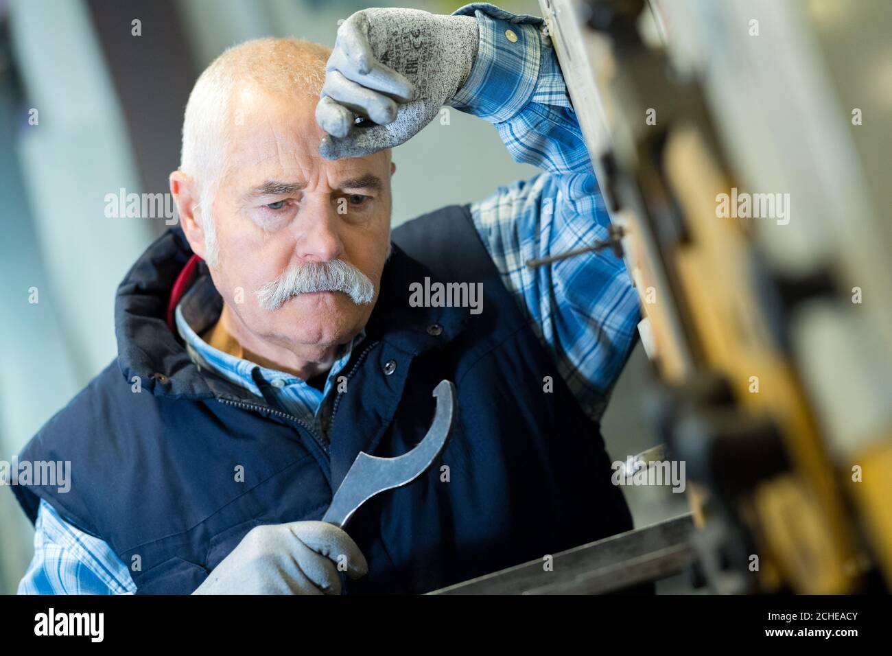 portrait of a tired senior worker Stock Photo - Alamy