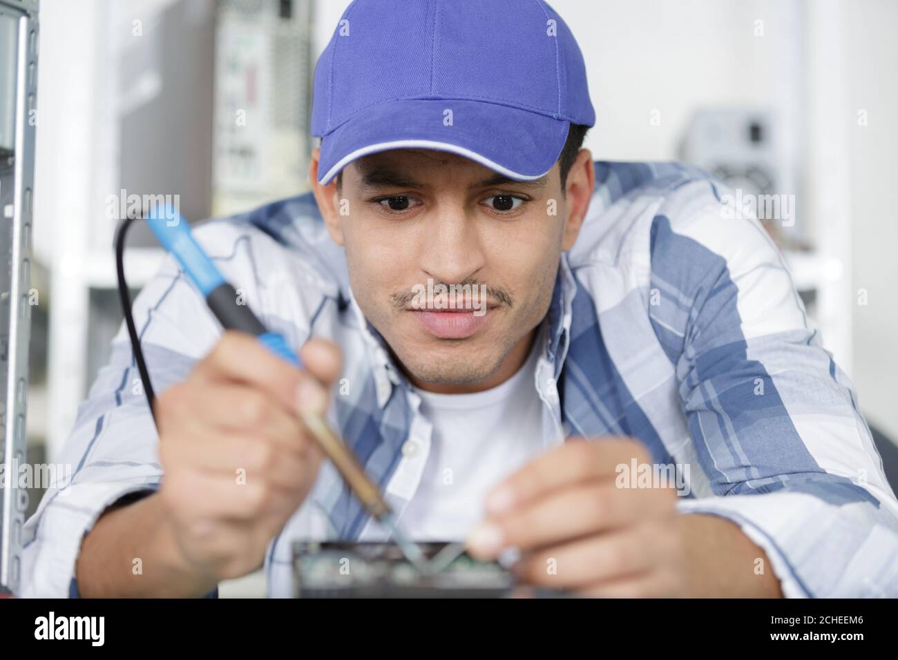 young man soldering a circuit board Stock Photo - Alamy