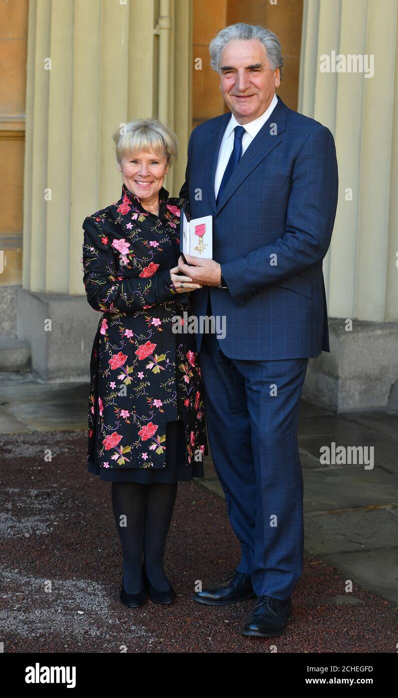 Jim Carter stands with his wife Imelda Staunton, as he holds his OBE ...