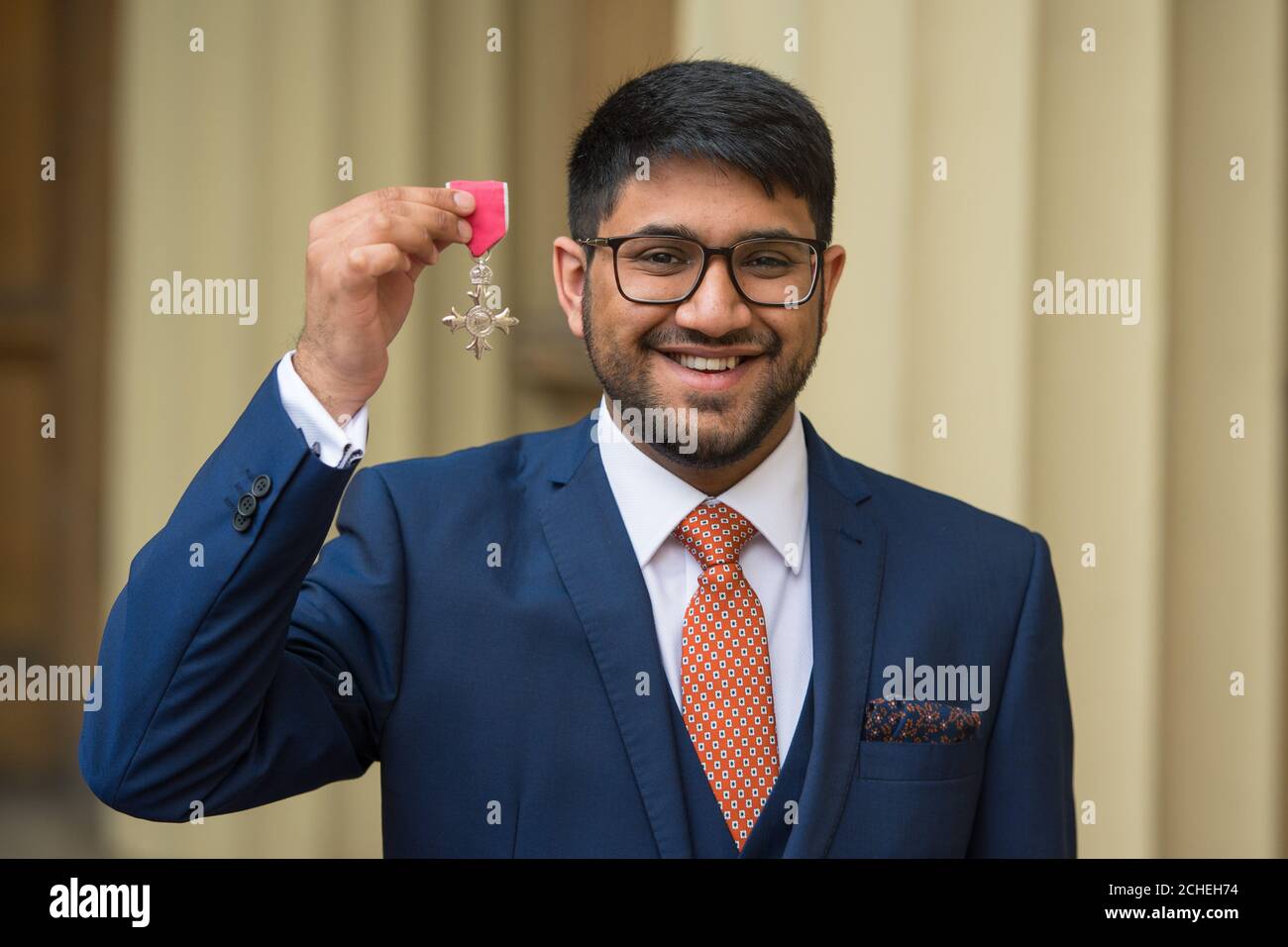 Saeed Atcha with his MBE medal, awarded to him during an investiture ...