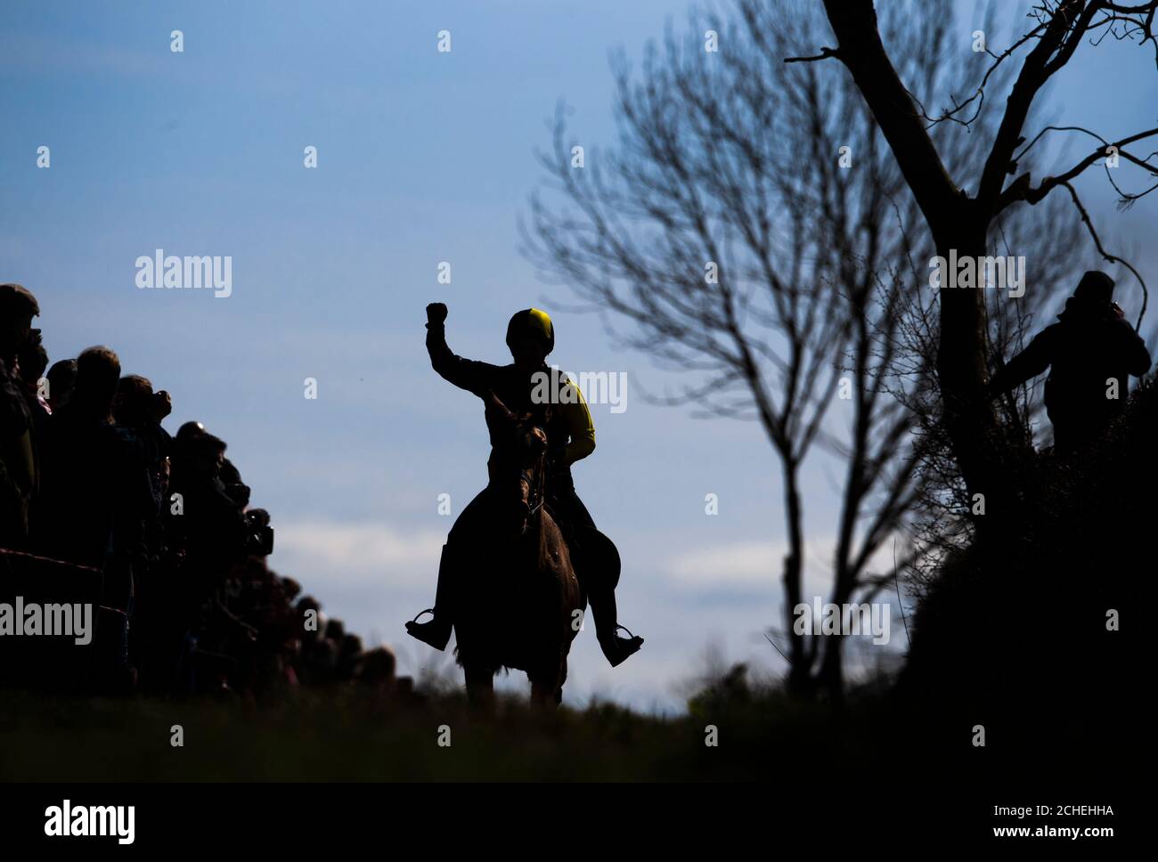 A riders cross the finish line during the Kiplingcotes Derby, England's ...