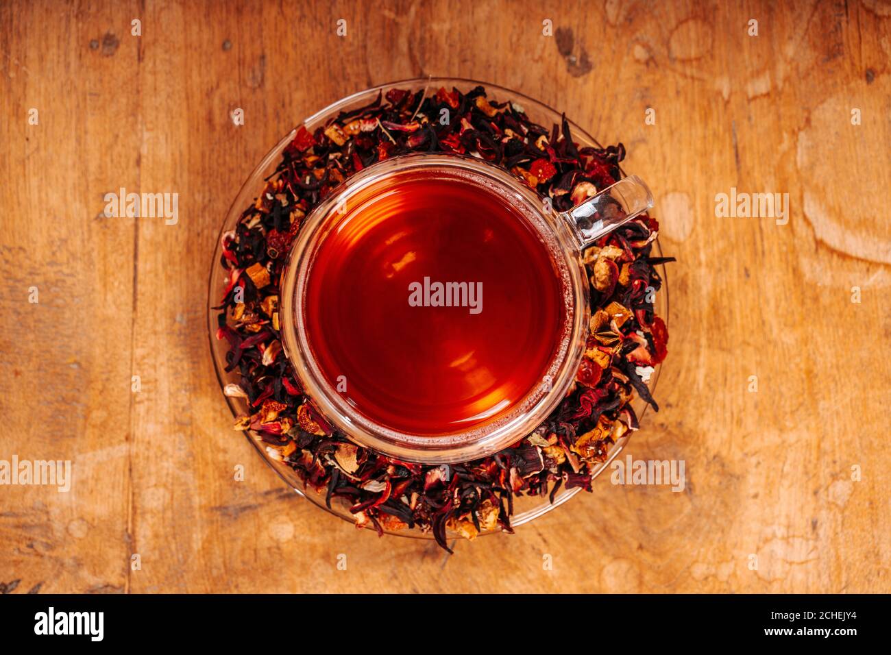 Cup of hot tea with rock sugar, dry tea leaves served in thermo glass ...