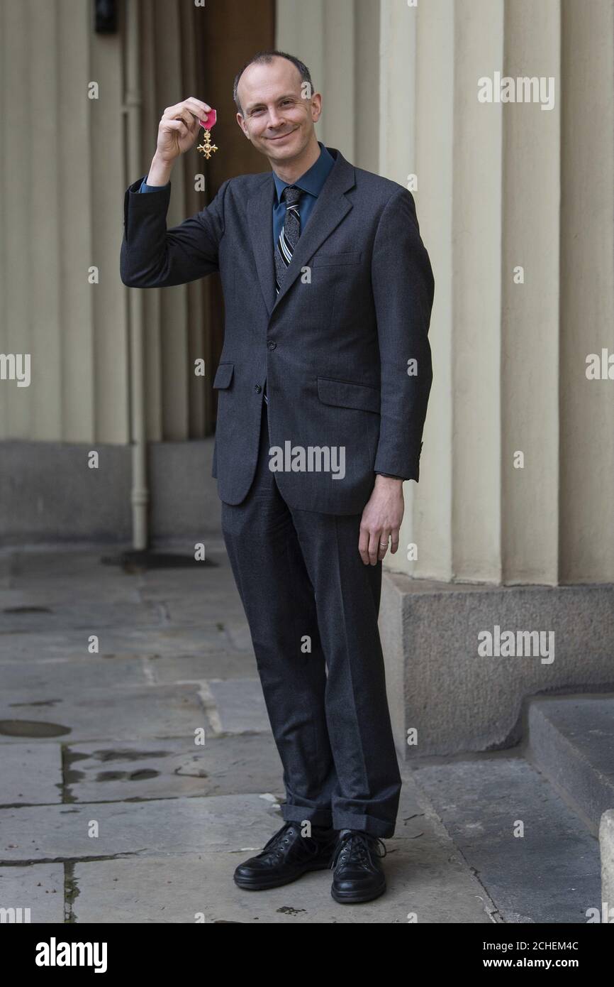 Economist and Journalist Tim Harford with his OBE after an investiture ...